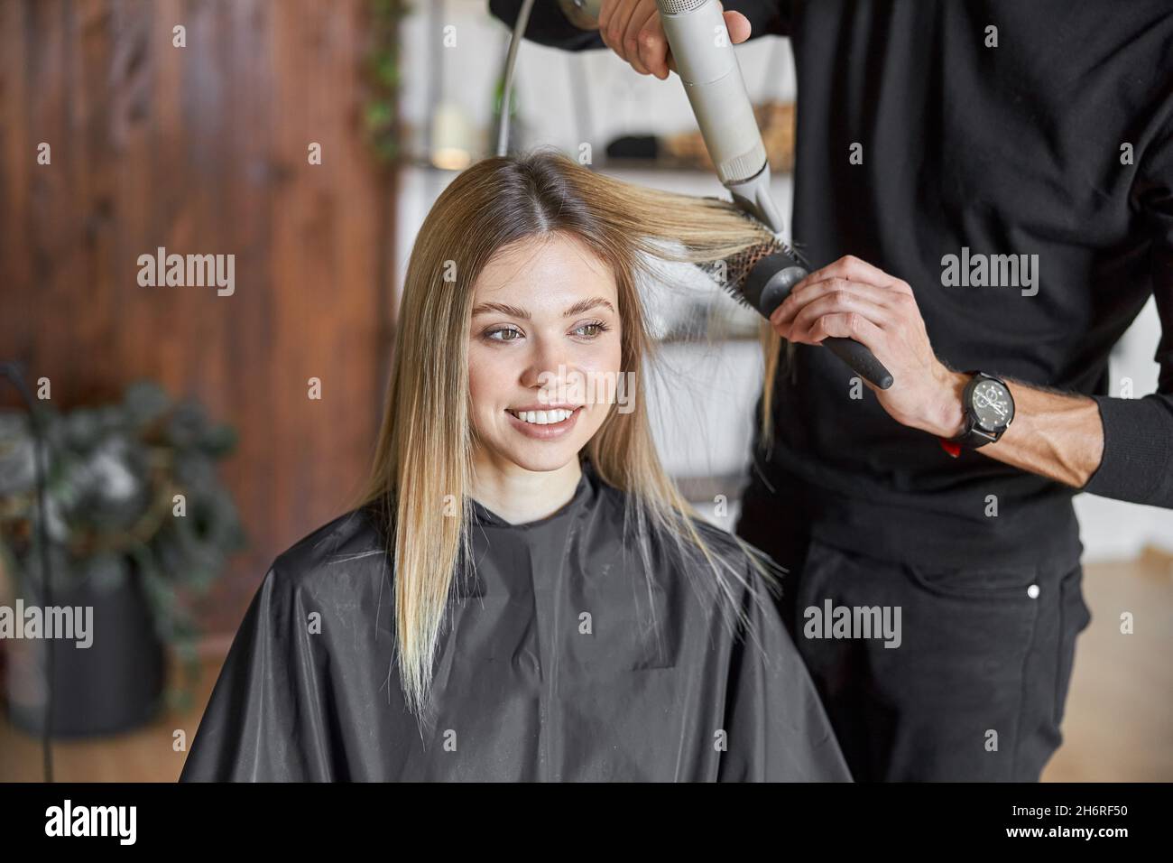 Hair drying process in modern hairdresser's salon Stock Photo - Alamy
