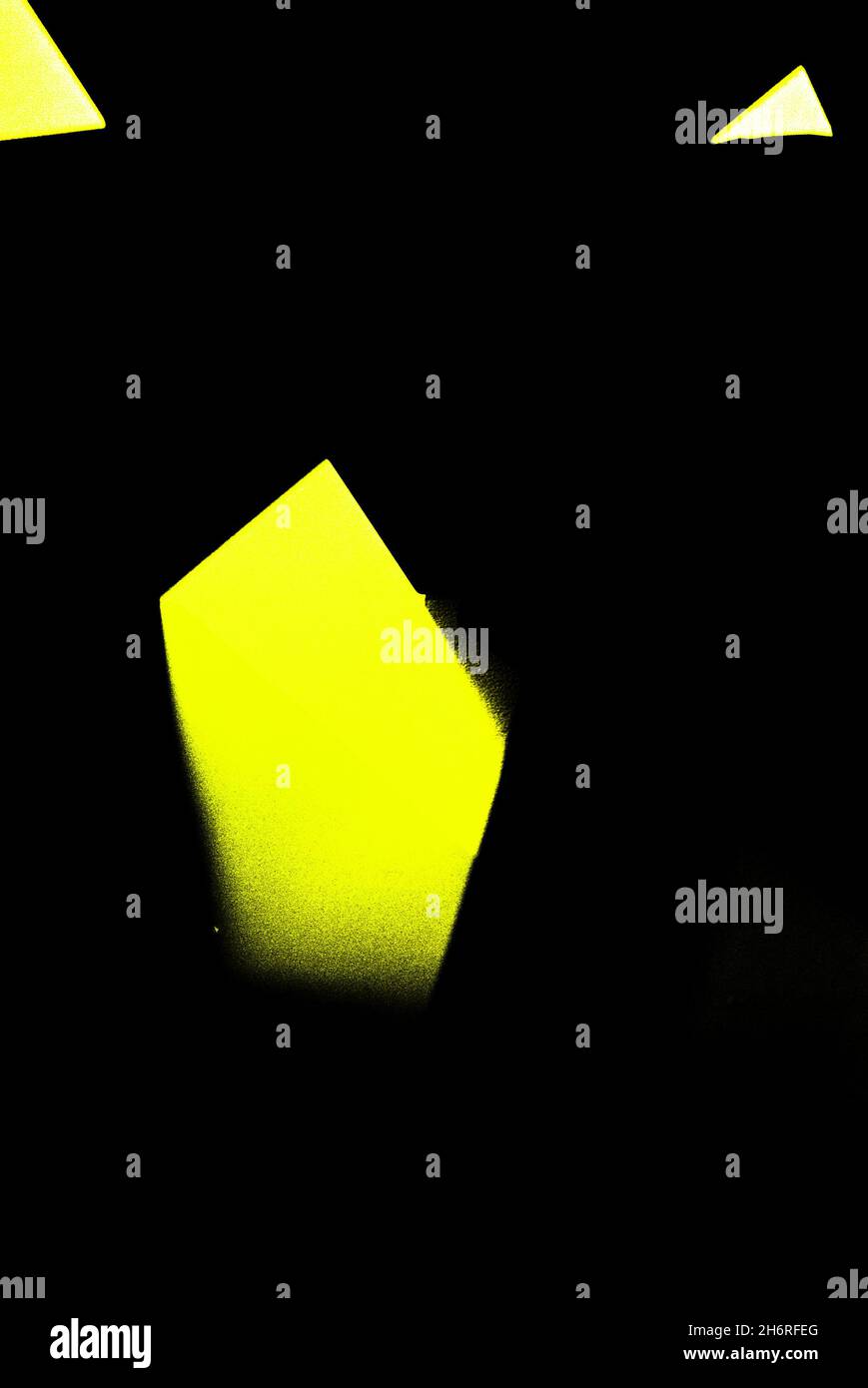 Vertical shot of the yellow lights of pentagon and triangle shapes on ...
