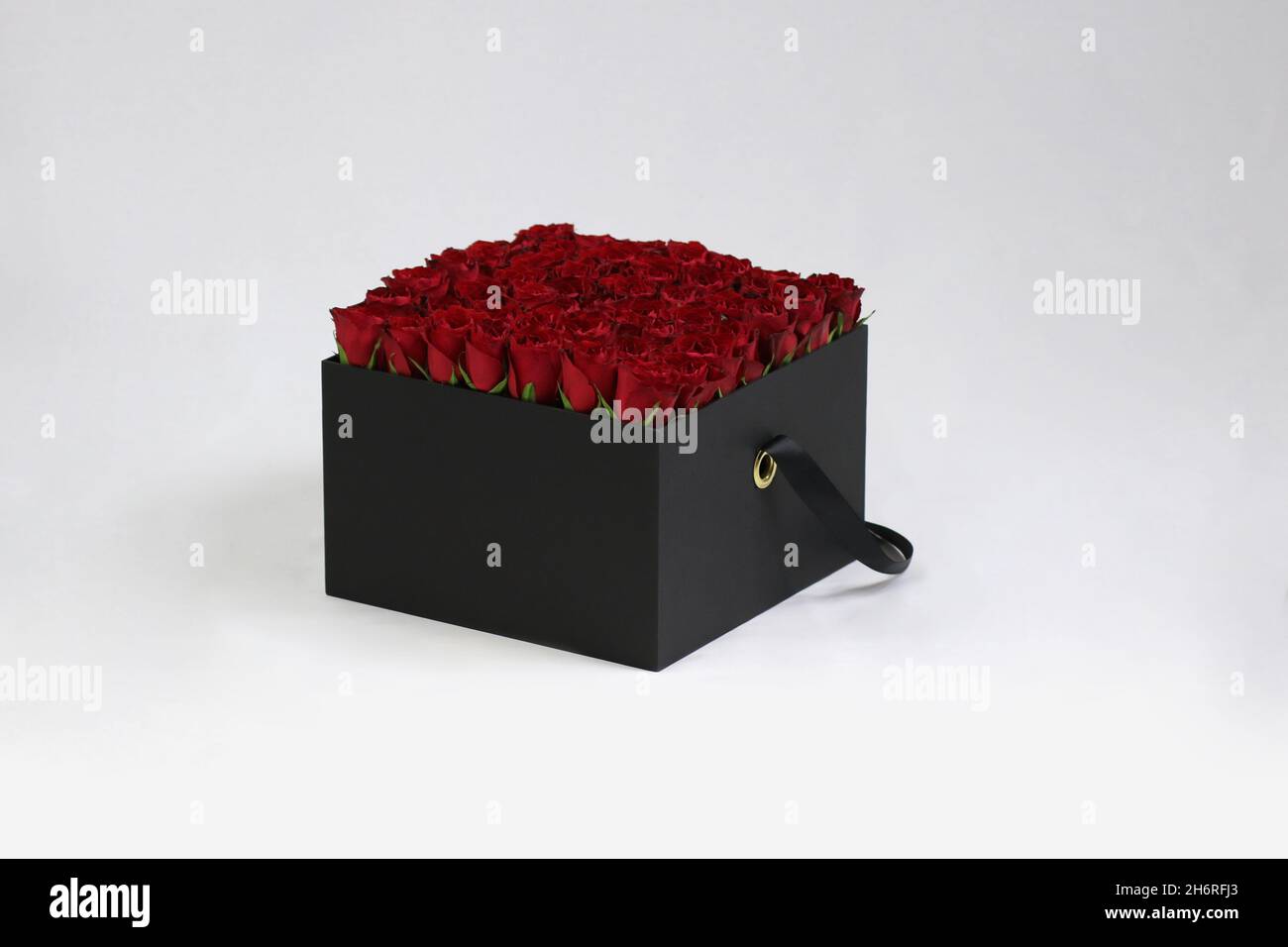 Black square gift flower box with red roses inside Stock Photo - Alamy