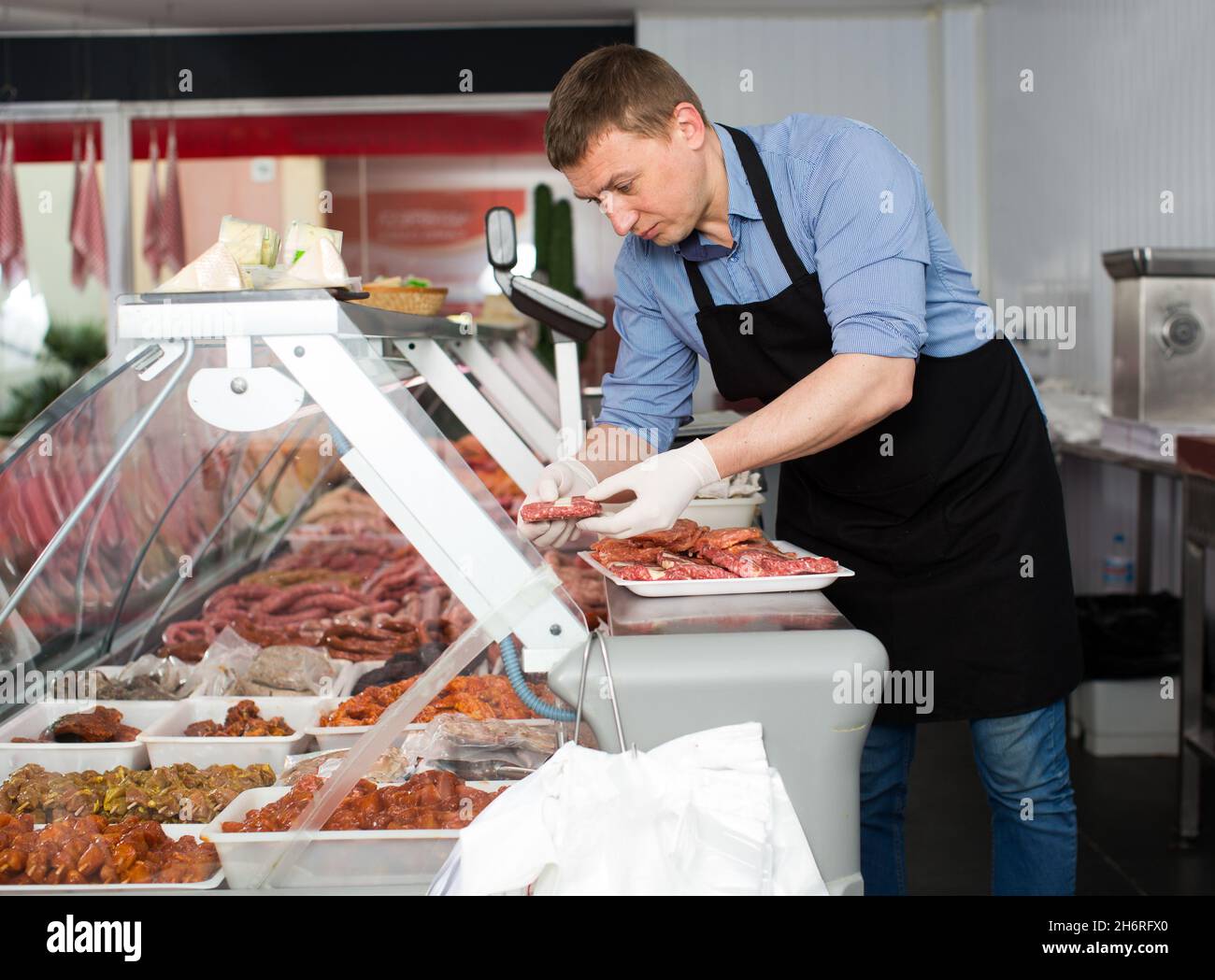 Butcher arranging meat display hi-res stock photography and images - Alamy