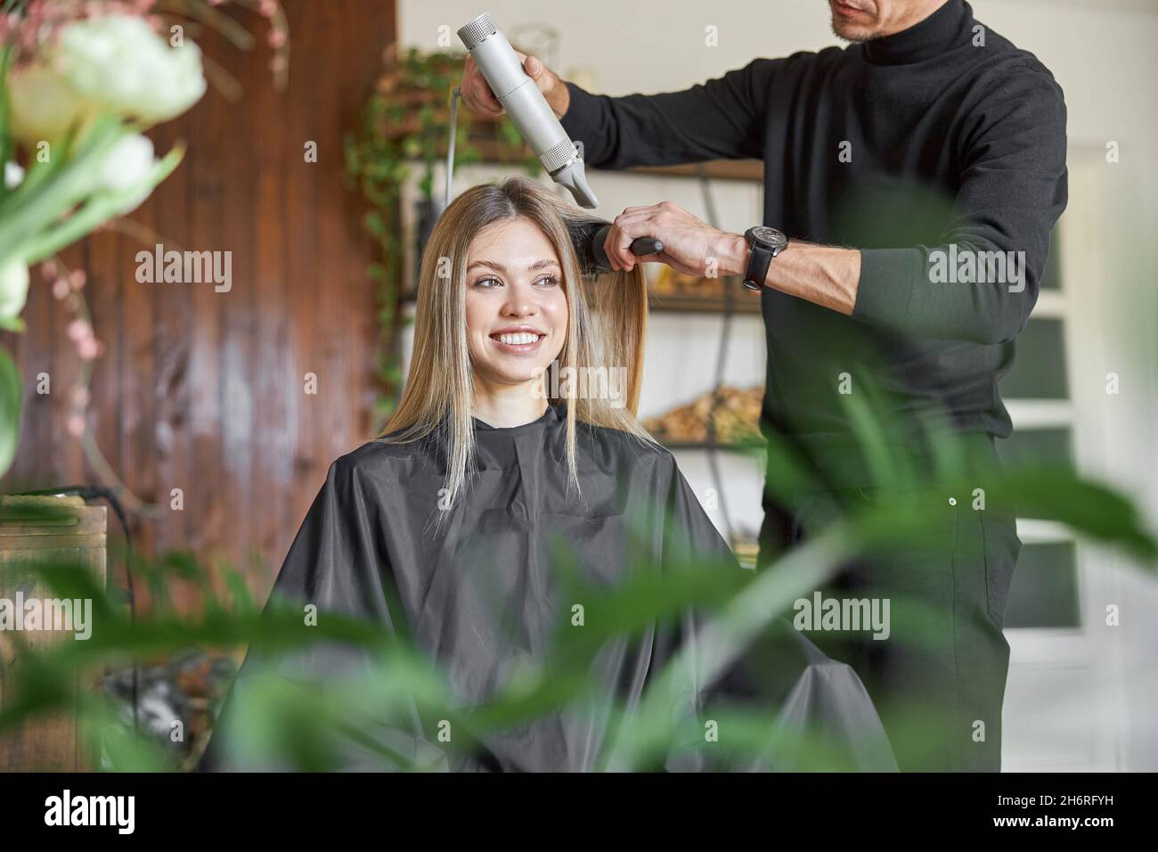Hair drying process in modern hairdresser's salon Stock Photo - Alamy