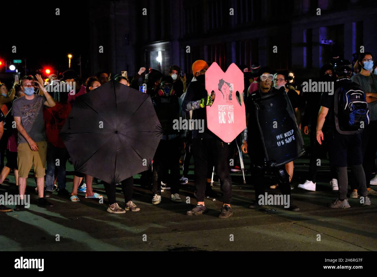 Kenosha, WI, USA. 25th Aug, 2020. Protesters stand in front of a police ...