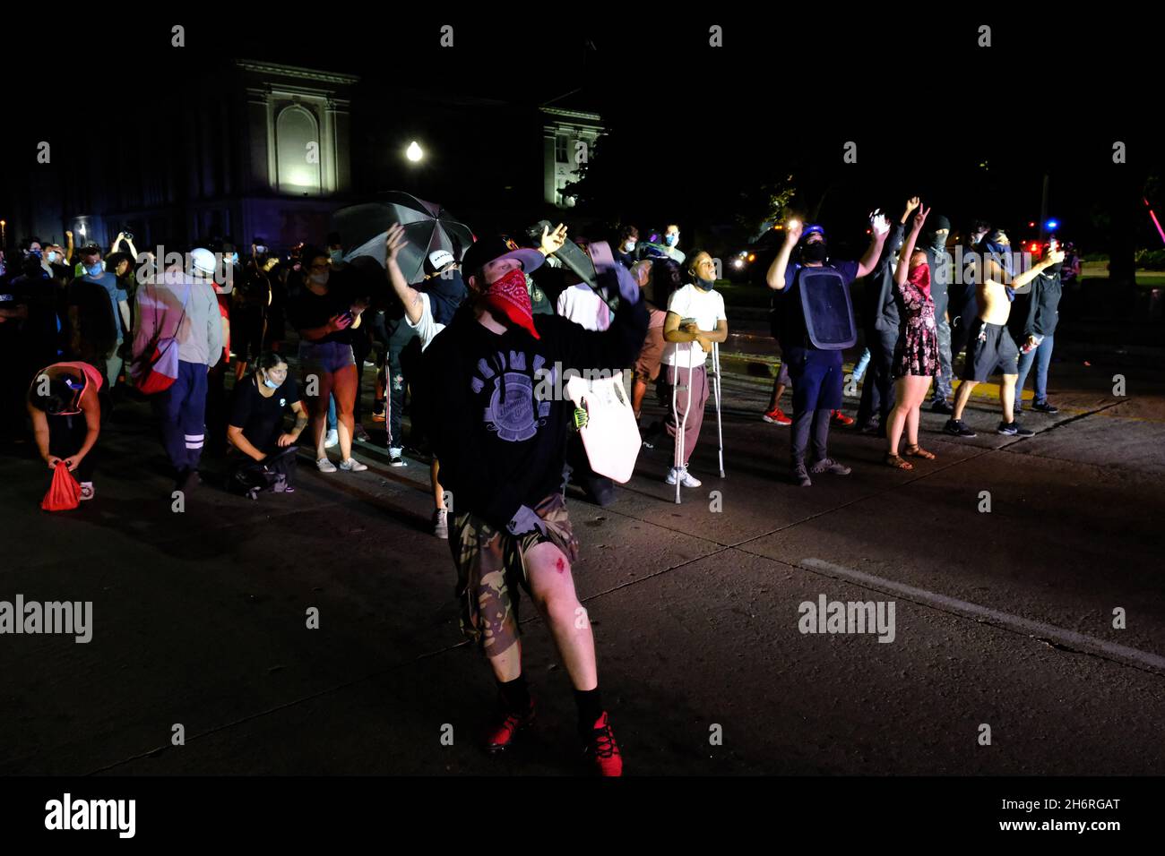 Kenosha, WI, USA. 25th Aug, 2020. Protesters stand in front of a police ...
