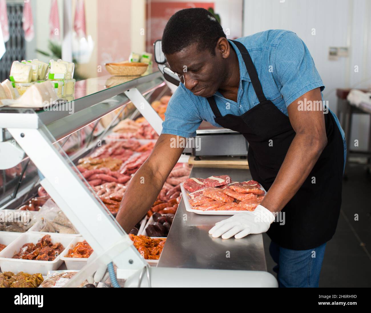 Butcher arranging meat display hi-res stock photography and images - Alamy