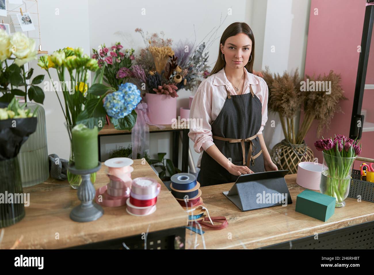 Professional florist young woman is doing bouquets at flower shop Stock ...