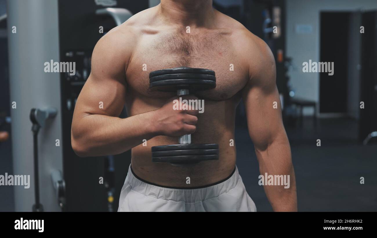 Muscular arab man training with dumbbells in the gym Stock Photo - Alamy