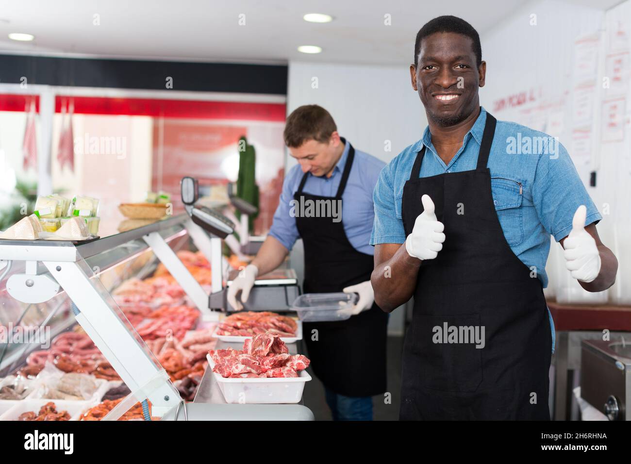 African American butcher giving thumbs up Stock Photo - Alamy