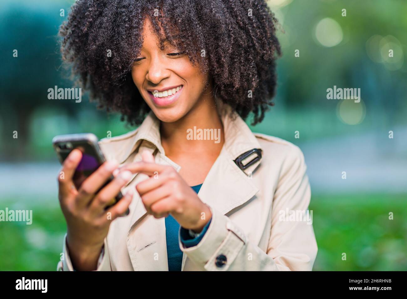 Mobile Technology. Latin Dominican Republic woman with afro curly hair ...