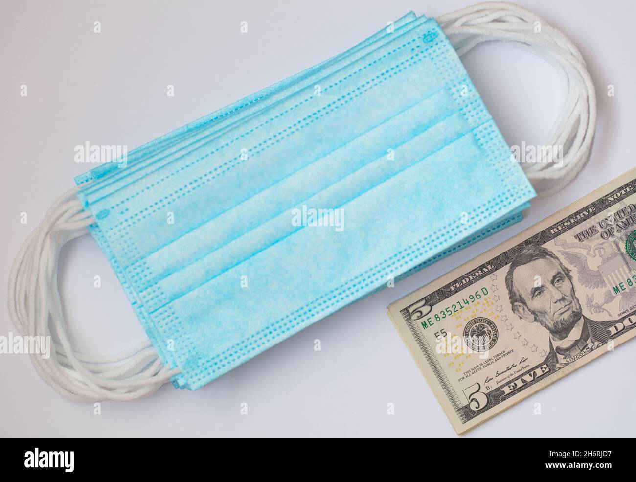 surgical masks and 5 dollar banknote Stock Photo - Alamy
