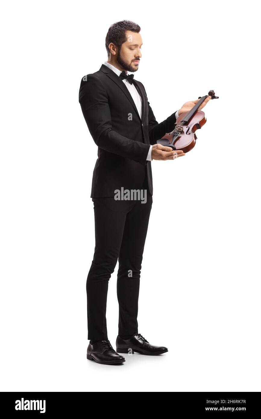 Full length shot of an elegant male violinist looking at a violin ...