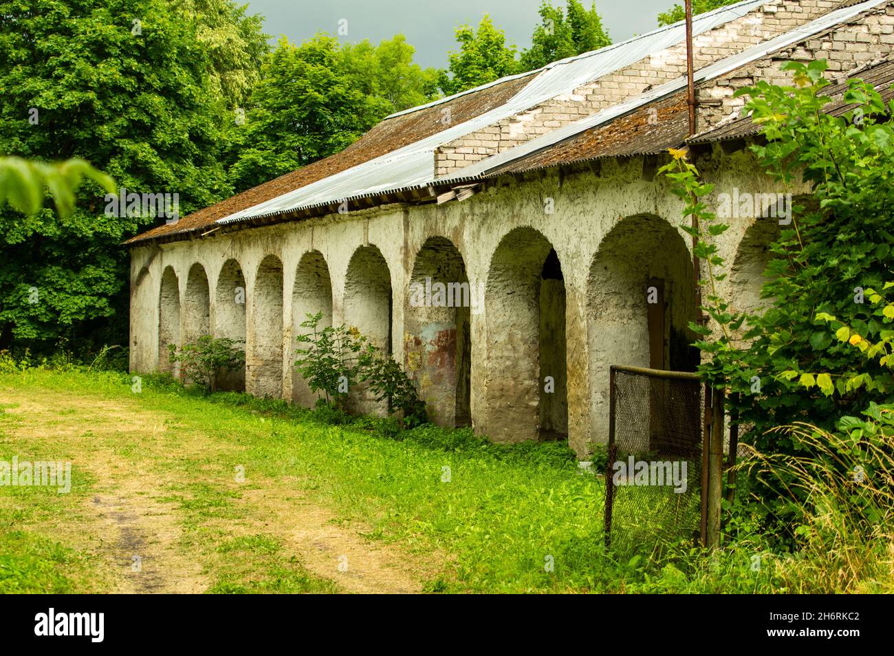 Old building covered in mosses in a garden in the daylight Stock Photo ...