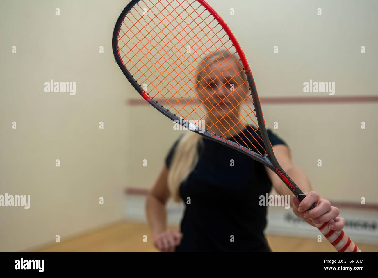 blonde girl holding a racket for squash games Stock Photo - Alamy
