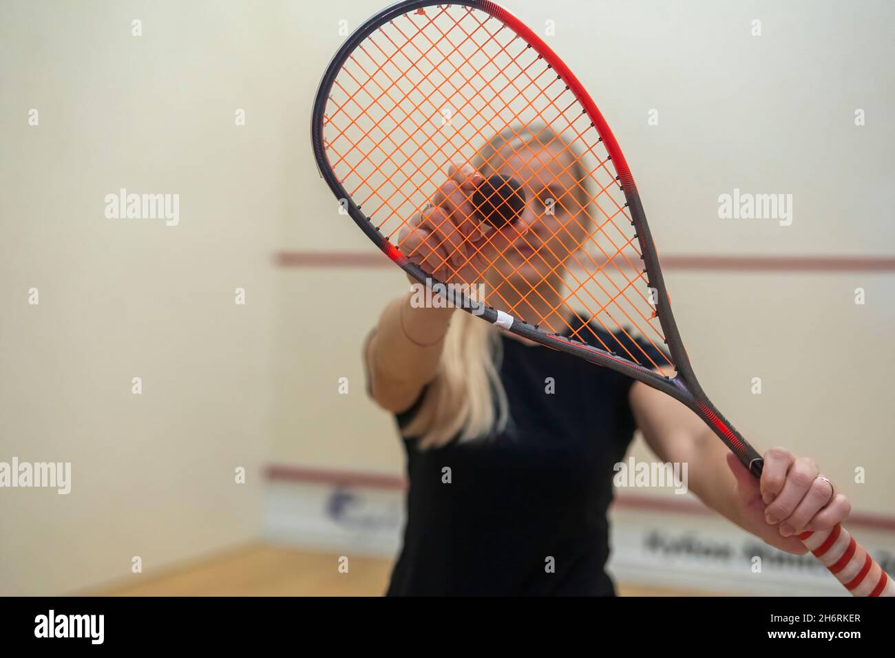 blonde girl holding a racket for squash games Stock Photo - Alamy