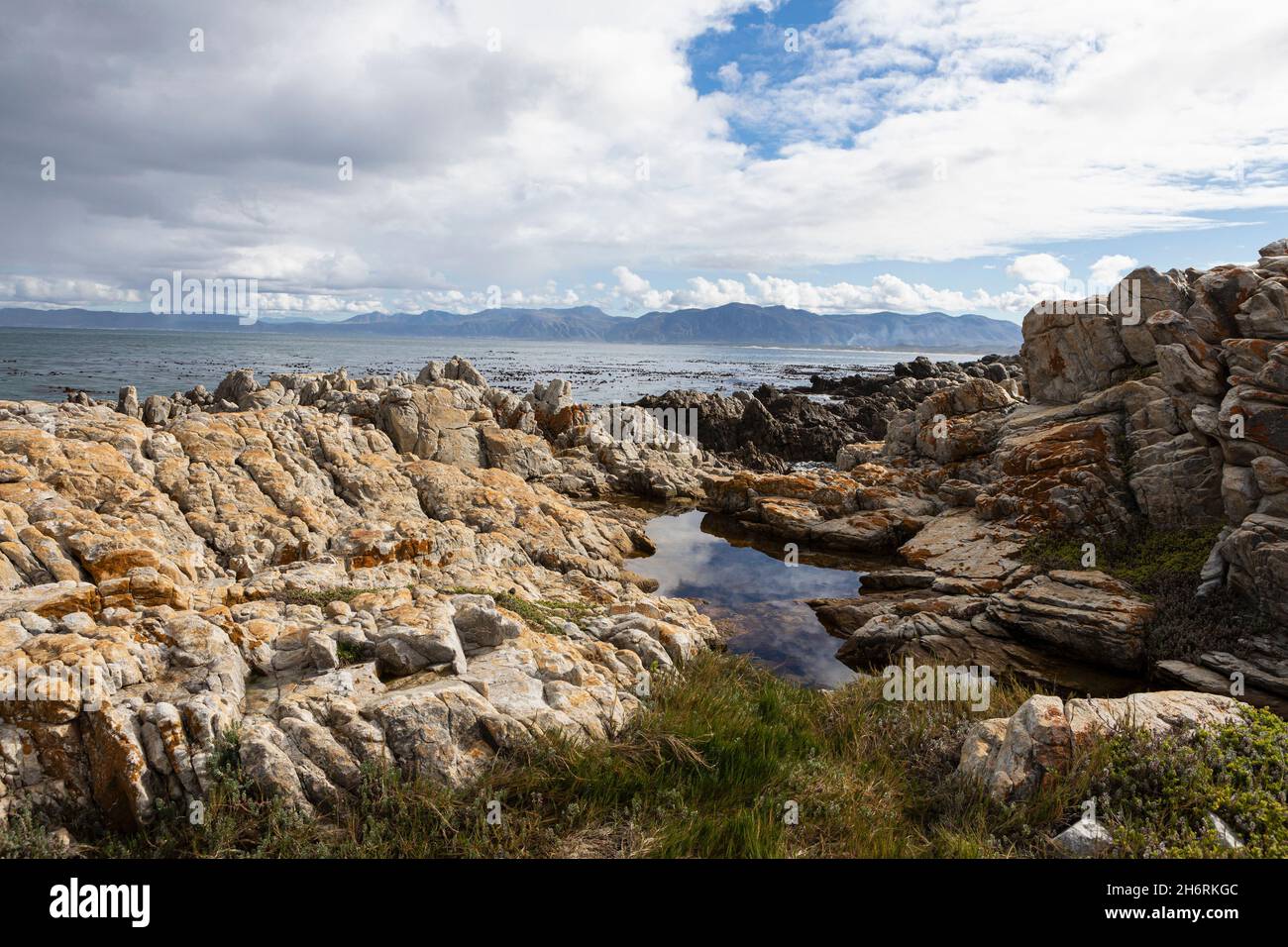 Rocky jagged coastline, rock pool and view out to the ocean Stock Photo ...