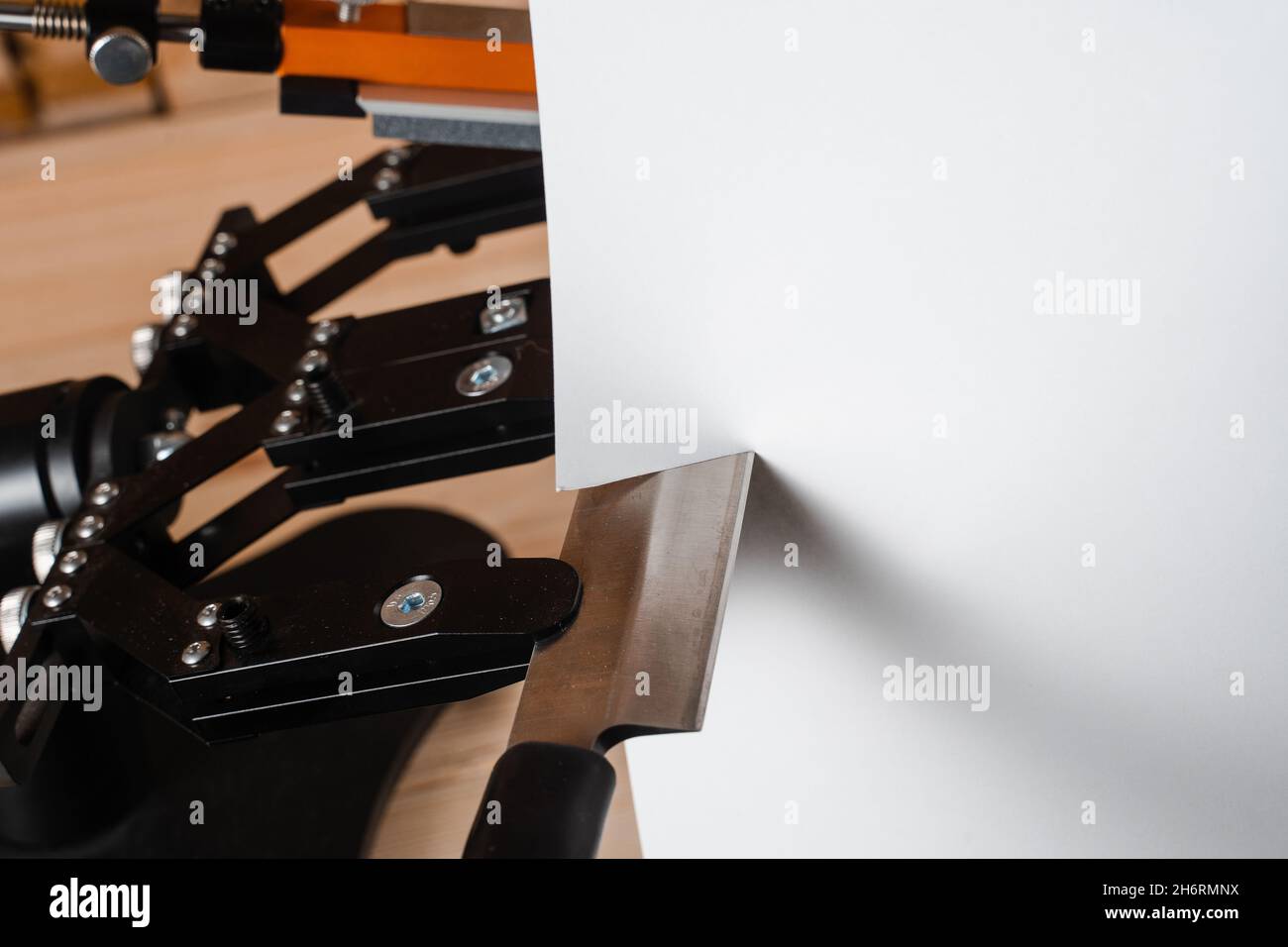 Process of cutting paper with a sharp knife near professional knife ...