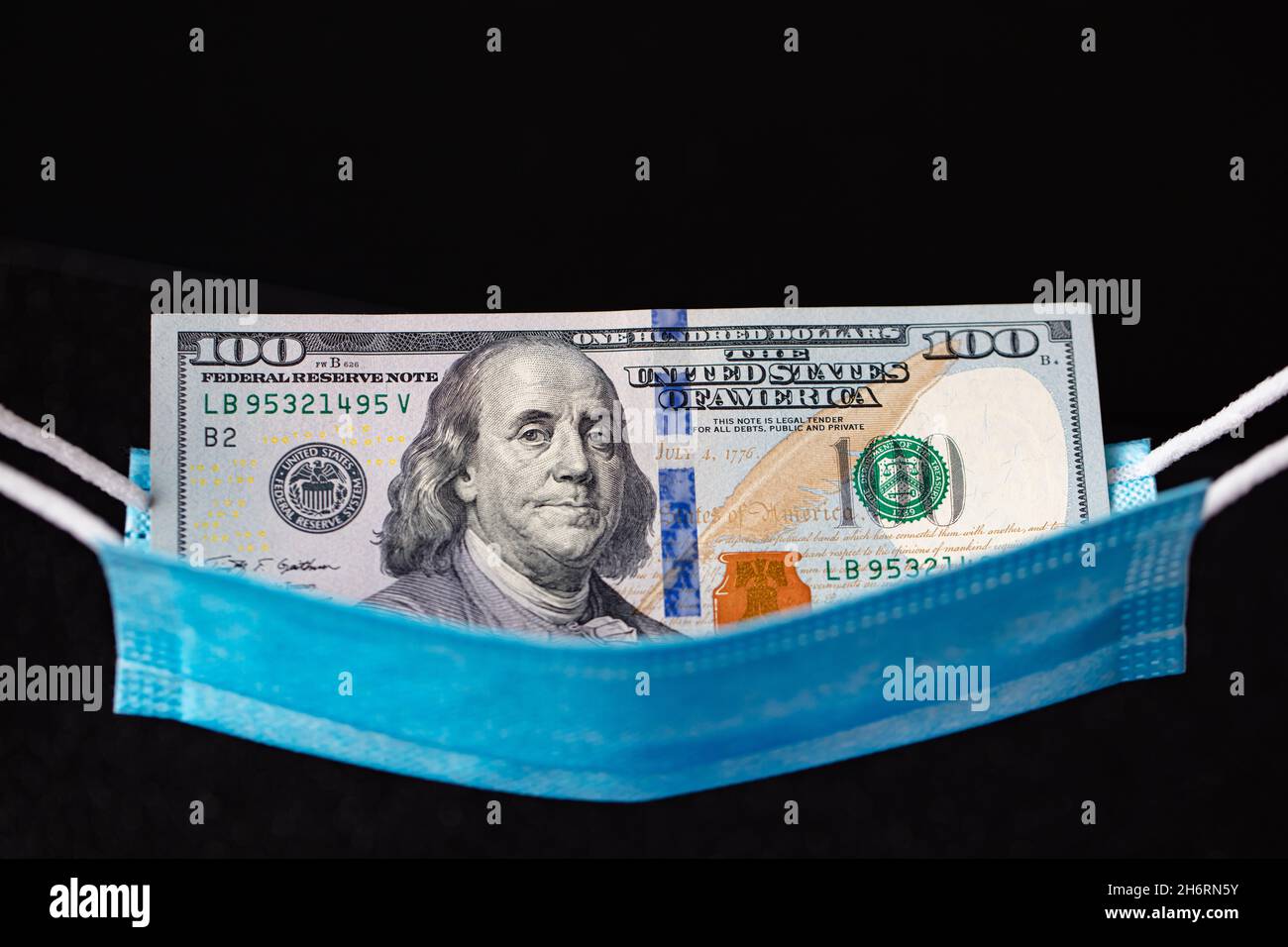 surgical mask as hammock with 100 dollar banknotes Stock Photo - Alamy