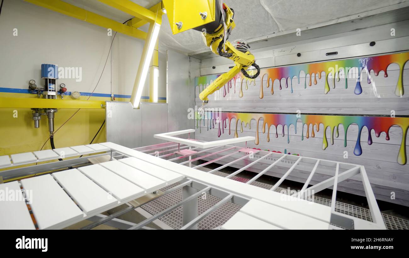 Industrial robotic arm paints frame. Action. Modern equipment for ...
