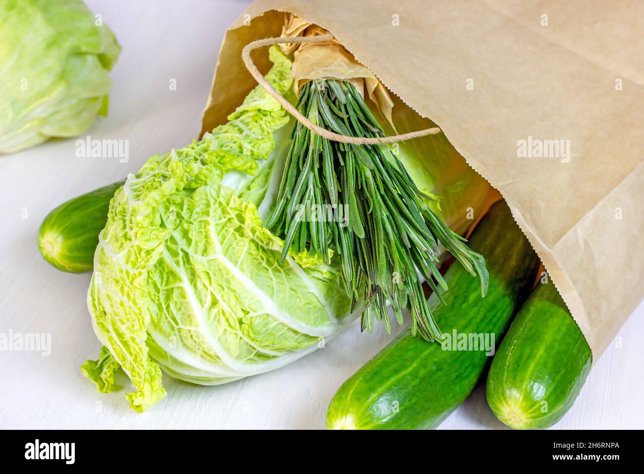 Fresh green vegetables (cucumbers, lettuce, rosemary and cabbage) in ...
