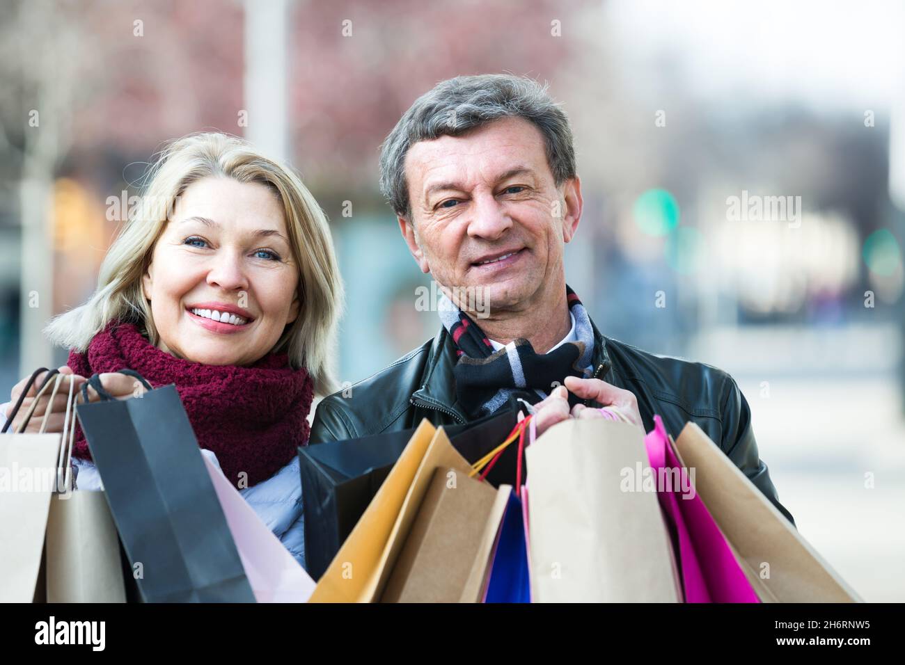 Mature spouses with shopping bags outdoor Stock Photo - Alamy