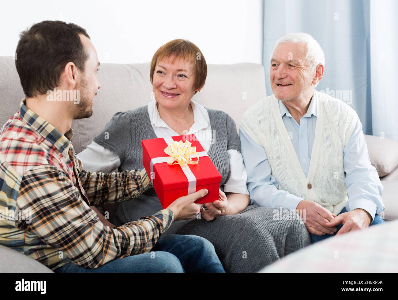 Son giving presents to parents Stock Photo - Alamy