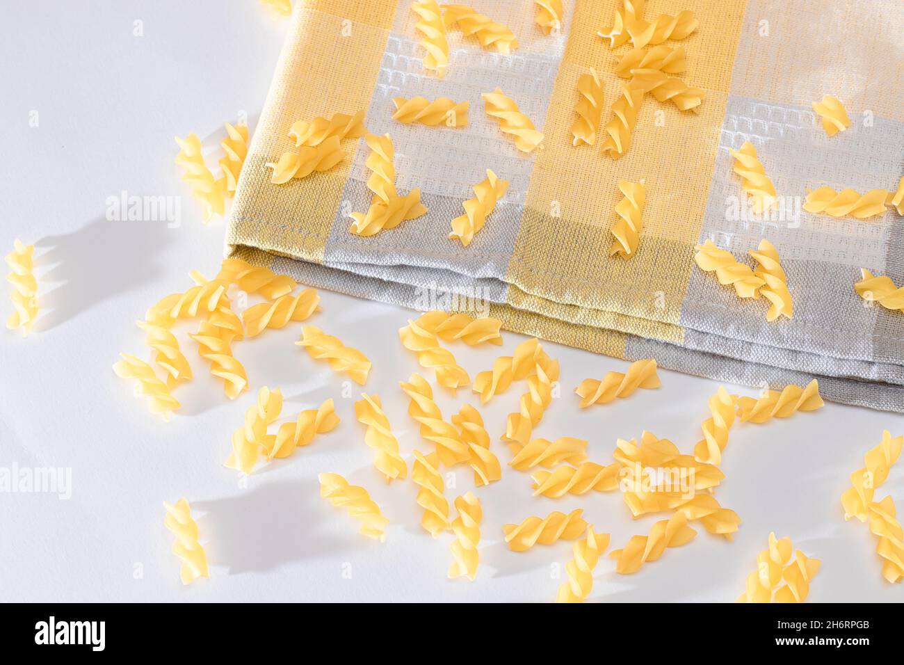 Uncooked Fusilli Pasta Scattered on White Table. Raw and Dry Macaroni ...