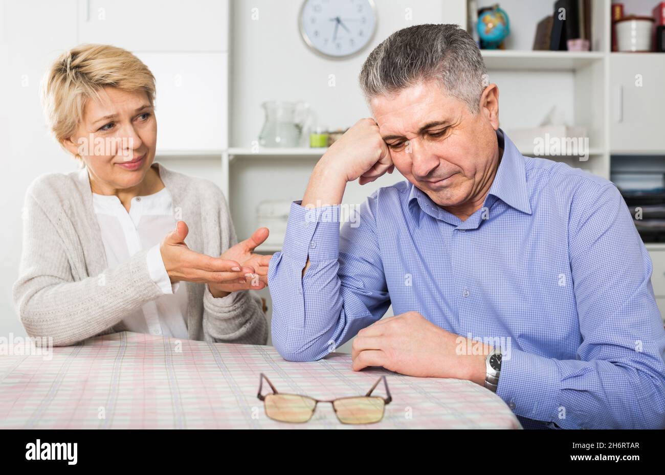 Husband and wife arguing with each other and try to resolve family ...