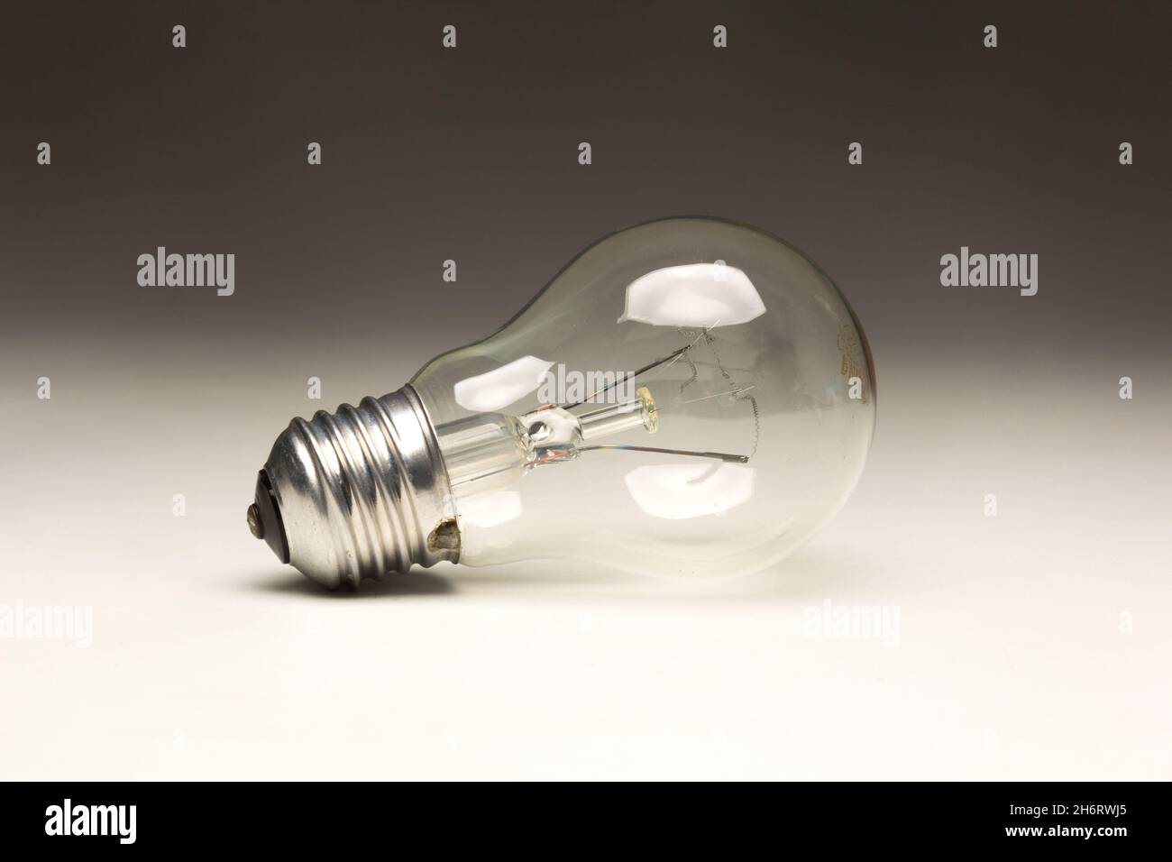 Clear glass incandescent filament bulb, analog technology Stock Photo ...