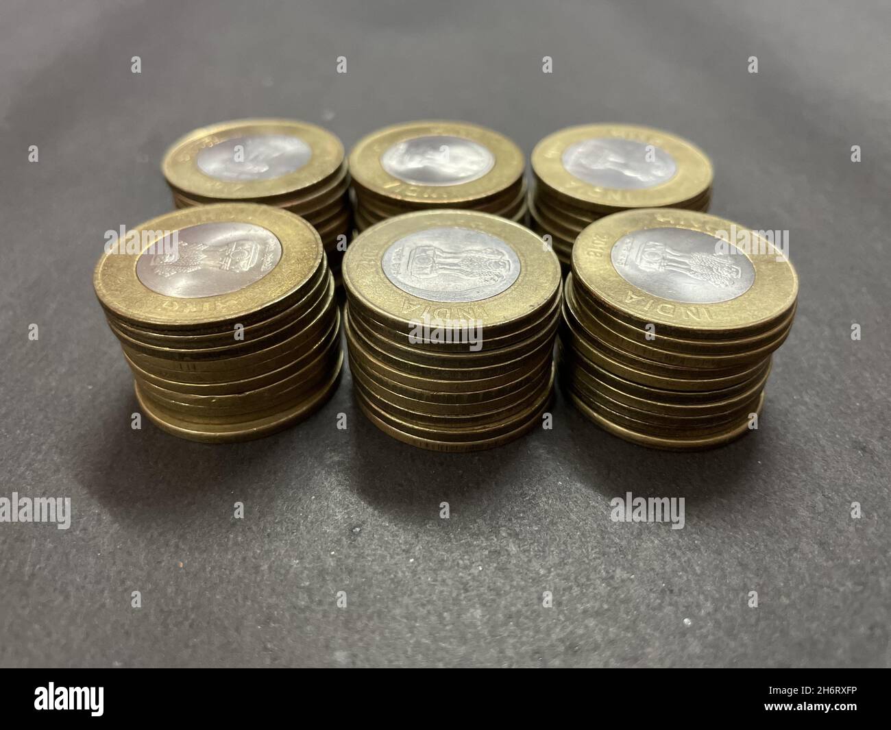 Closeup of stacks of Indian rupee coins with silver center and golden ...