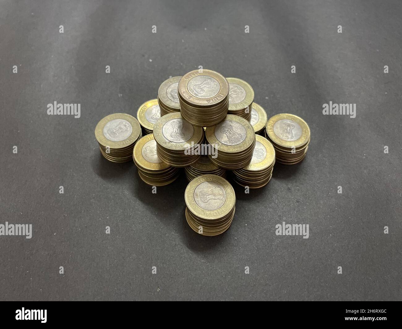 Closeup of stacks of Indian rupee coins with silver center and golden ...