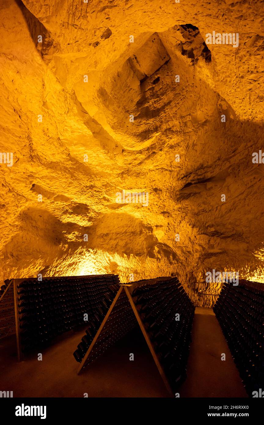 Bottles on racks in deep and long undergrounds caves, making champagne ...