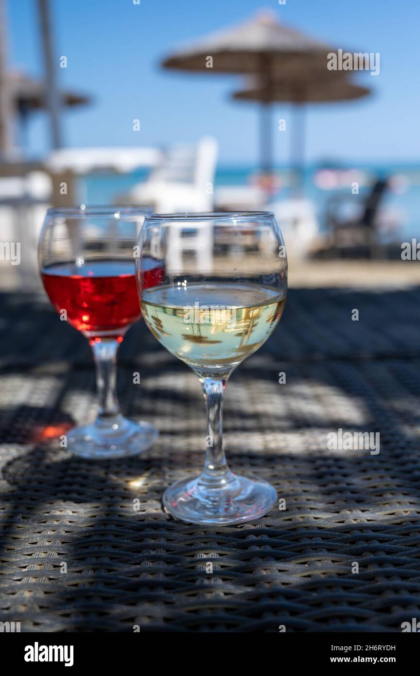 Drinking of cold rose and white wines in lounge bar on sunny sandy ...