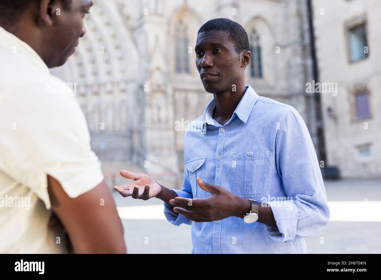 Conversation of two african americans on the street of european city on ...