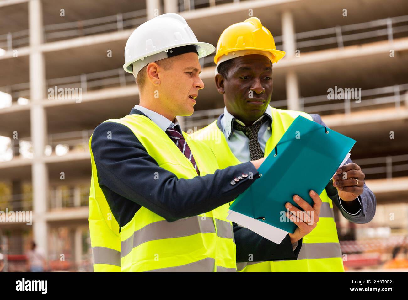 Engineers standing on construction site Stock Photo - Alamy