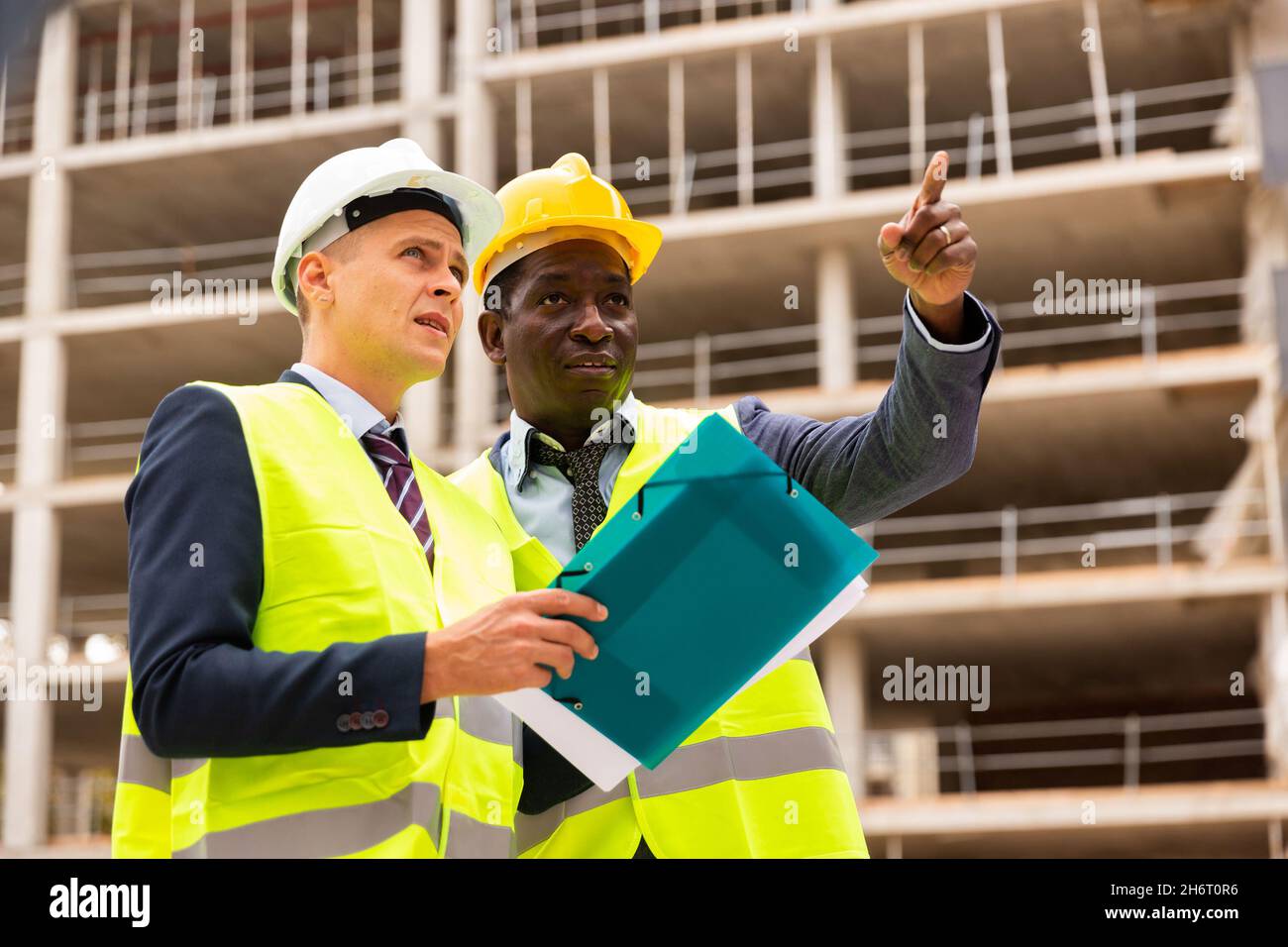 Engineers standing on construction site Stock Photo - Alamy