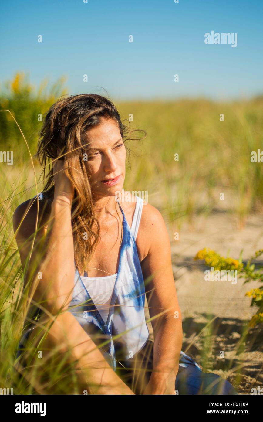 confident woman thinking on the beach Stock Photo - Alamy