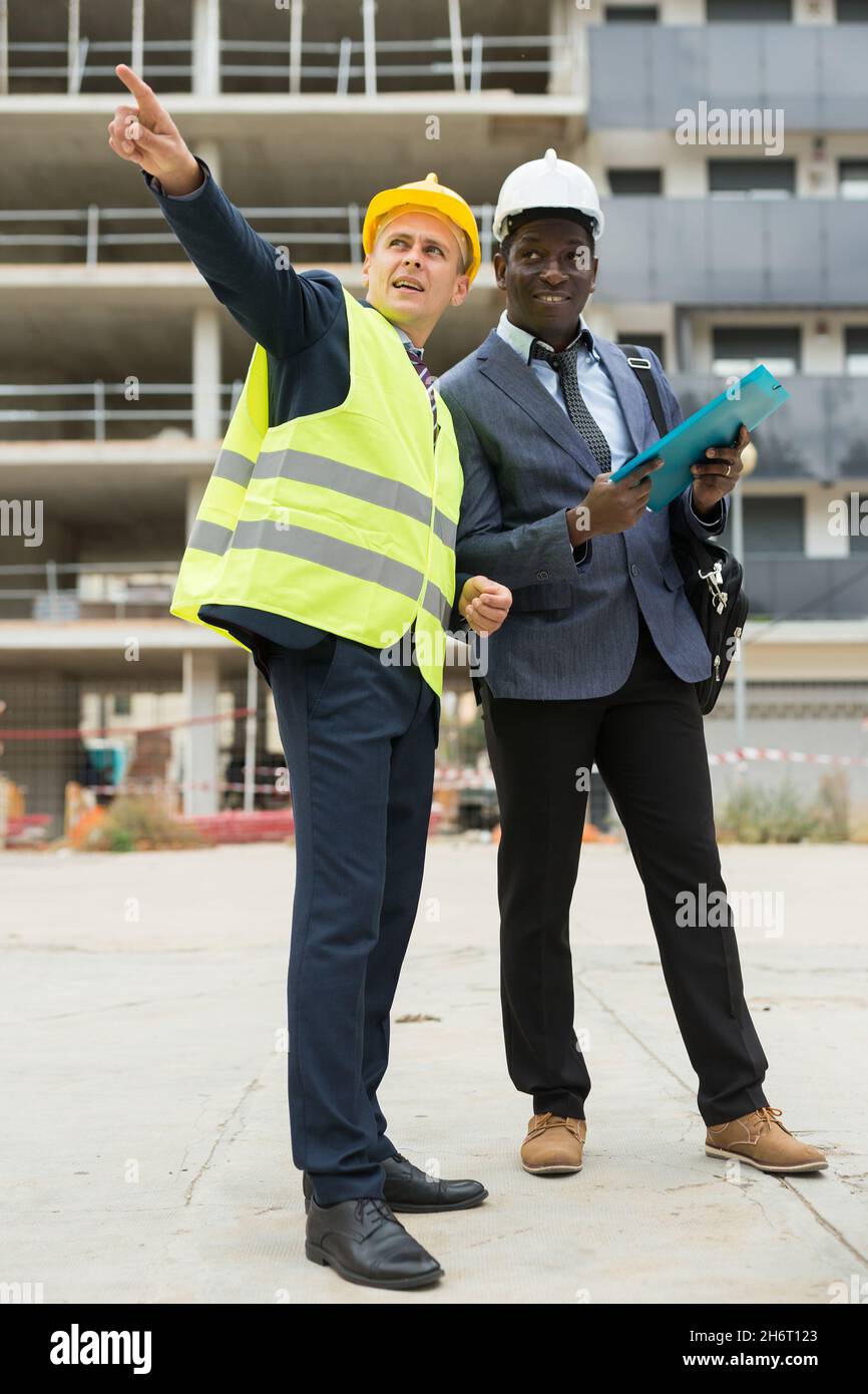 Two engineers discussing new construction Stock Photo - Alamy