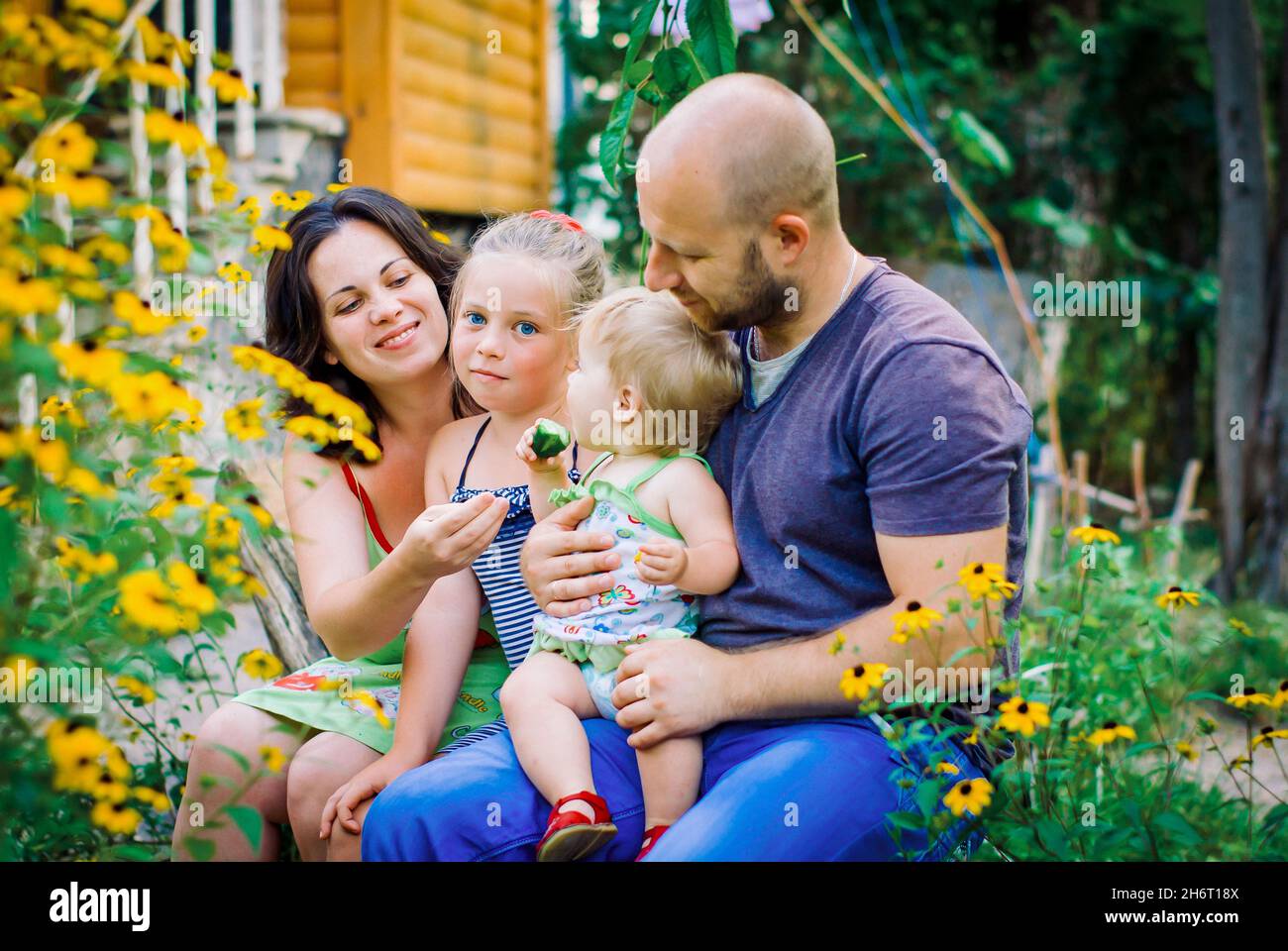 Portrait Of Happy Family In Garden At Home Stock Photo - Alamy