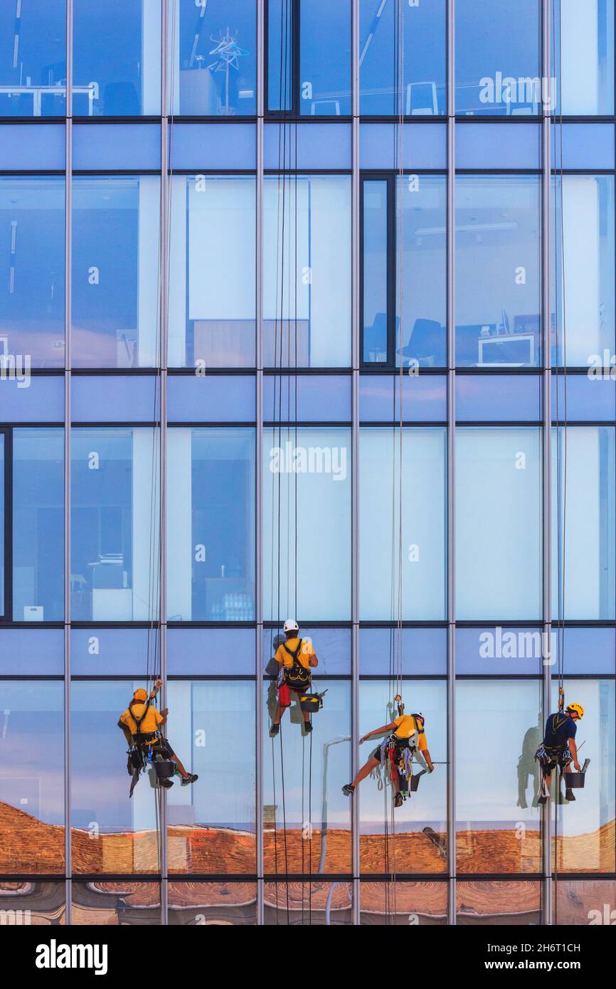 Urban landscape - a team of window washers during work at height ...
