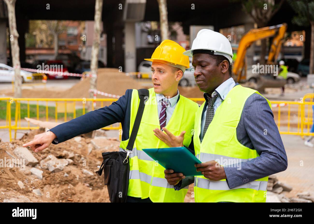 Architect tells engineer where to dig a trench to lay pipe Stock Photo ...