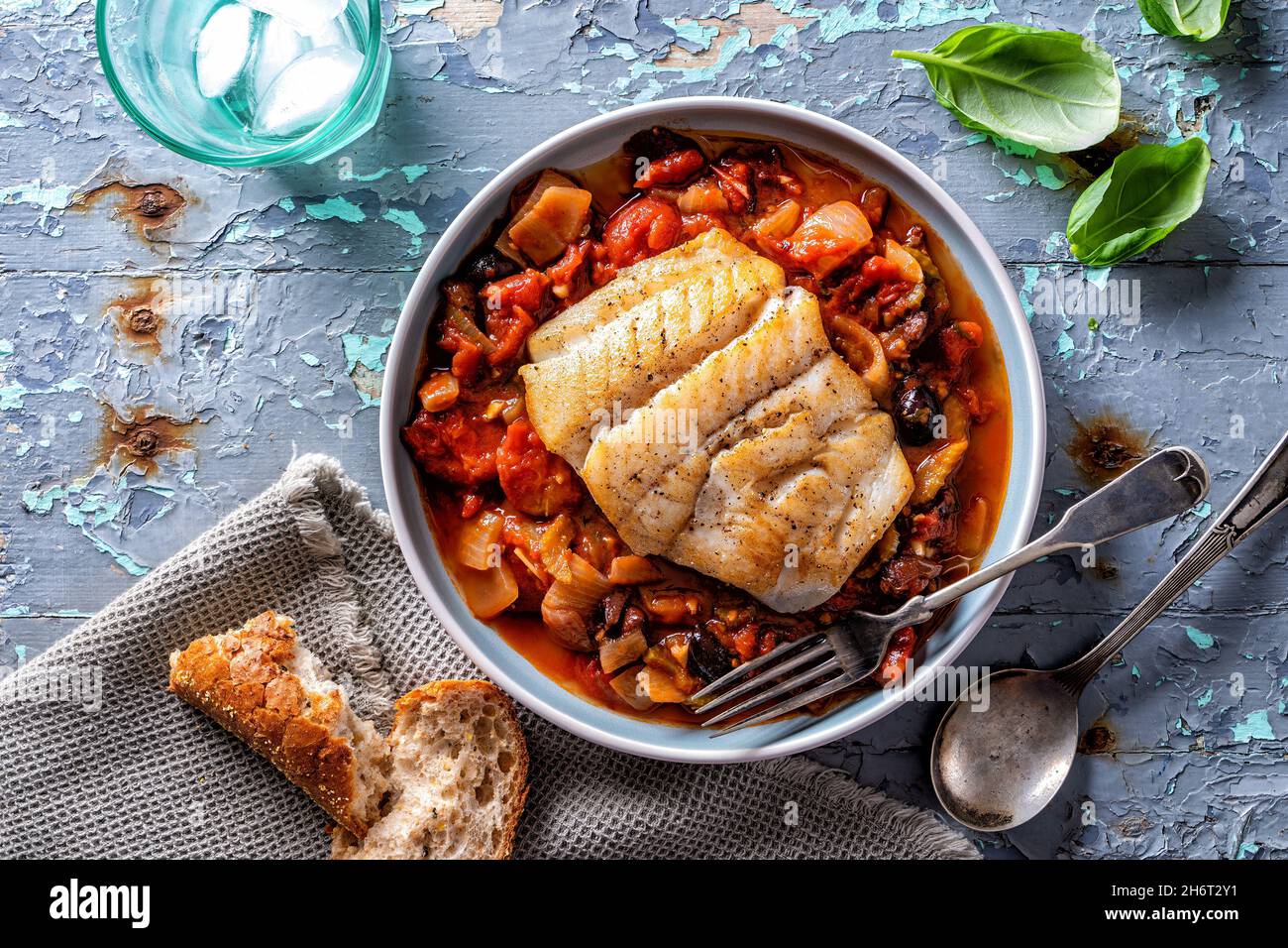 A plate of delicious Mediterranean style pan fried fish with tomato ...