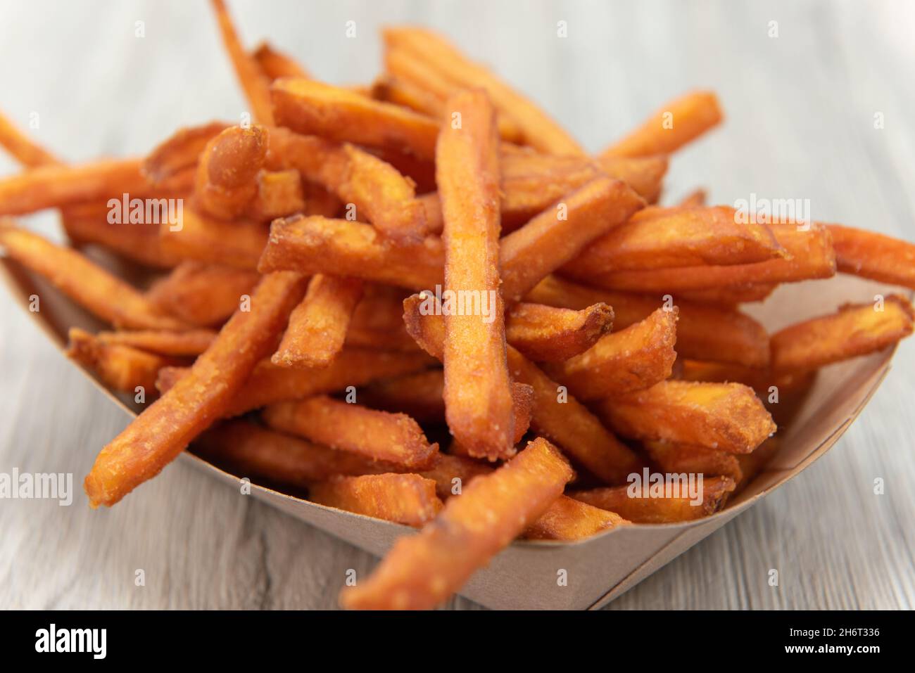 Crispy side dish of sweet potato french fries served in a cardboard ...