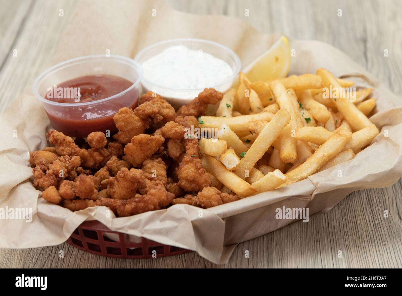 Combination basket full of deep fried clams and a side of french fries ...