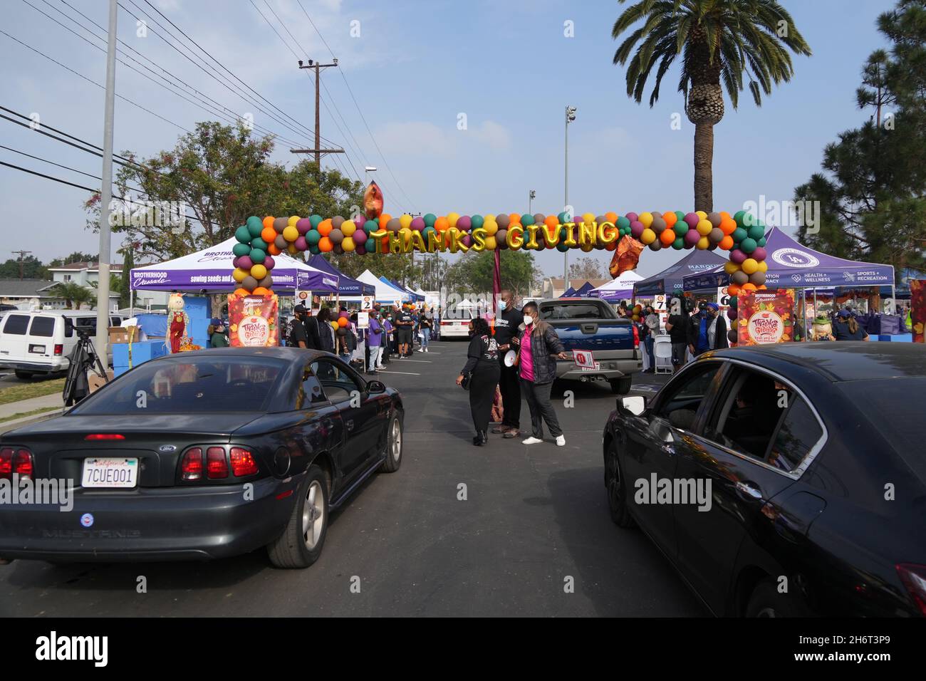 Motorists line up during the Los Angeles Dodgers Foundation Thanksgiving Grab and Go drive-thru ...
