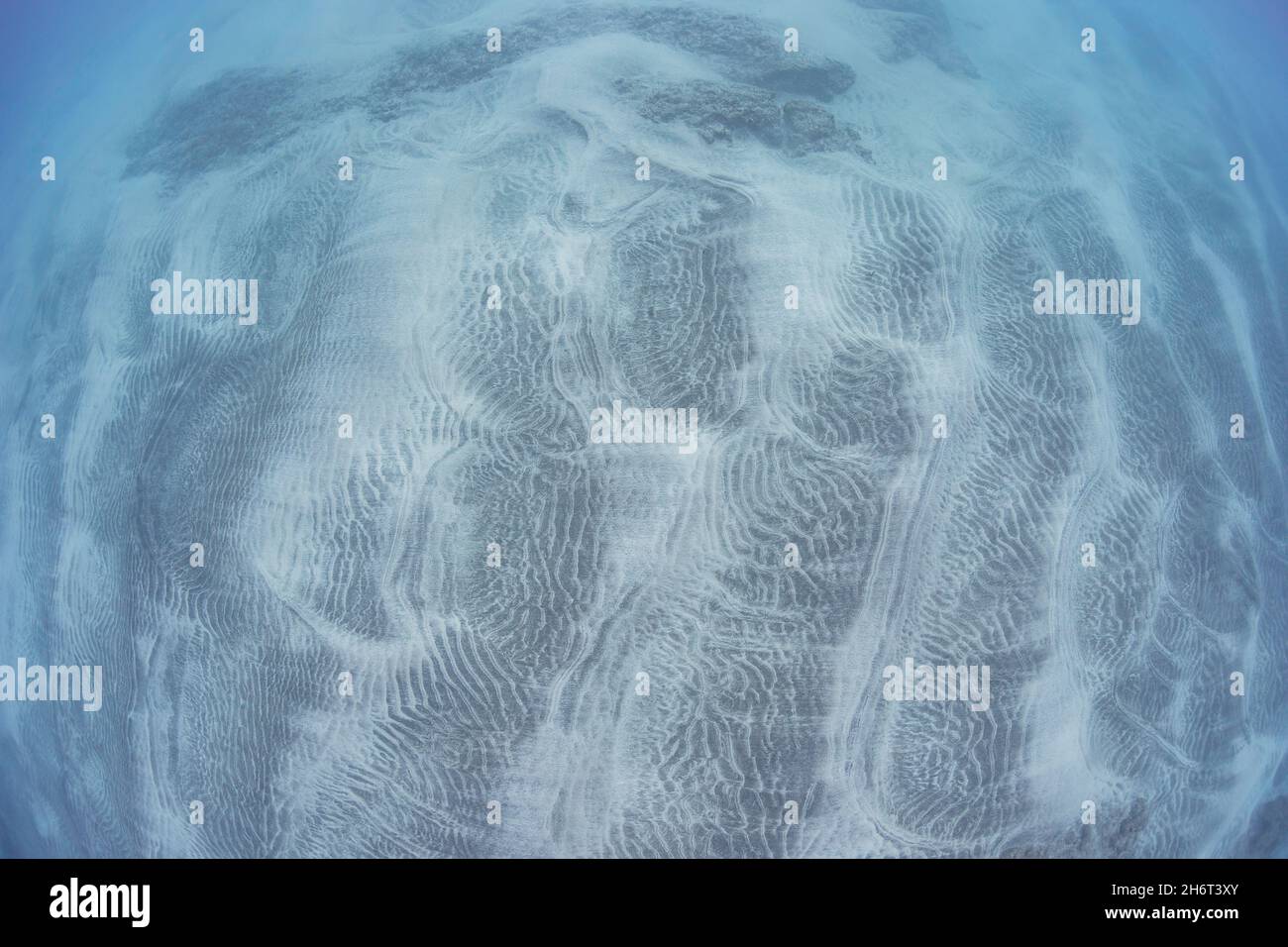Wave action creates patterns underwater in a sandy bottom, Hawaii Stock ...