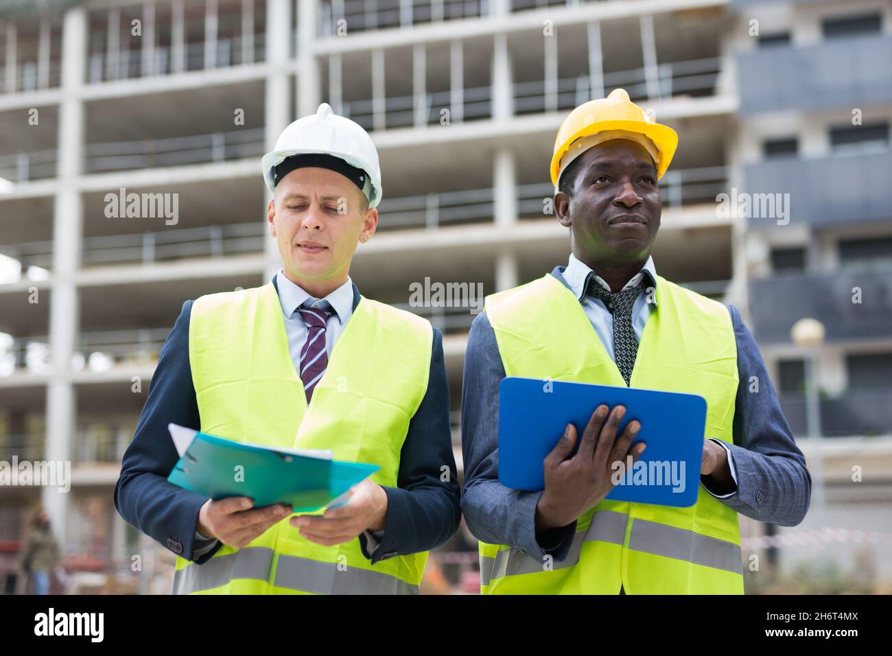 Engineers standing on construction site Stock Photo - Alamy