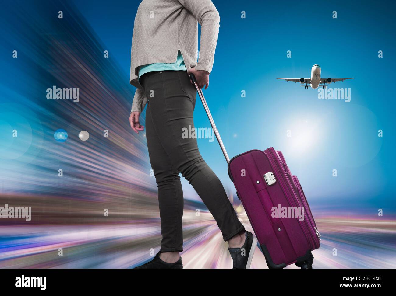 Woman with suitcase awaiting aircraft Stock Photo - Alamy
