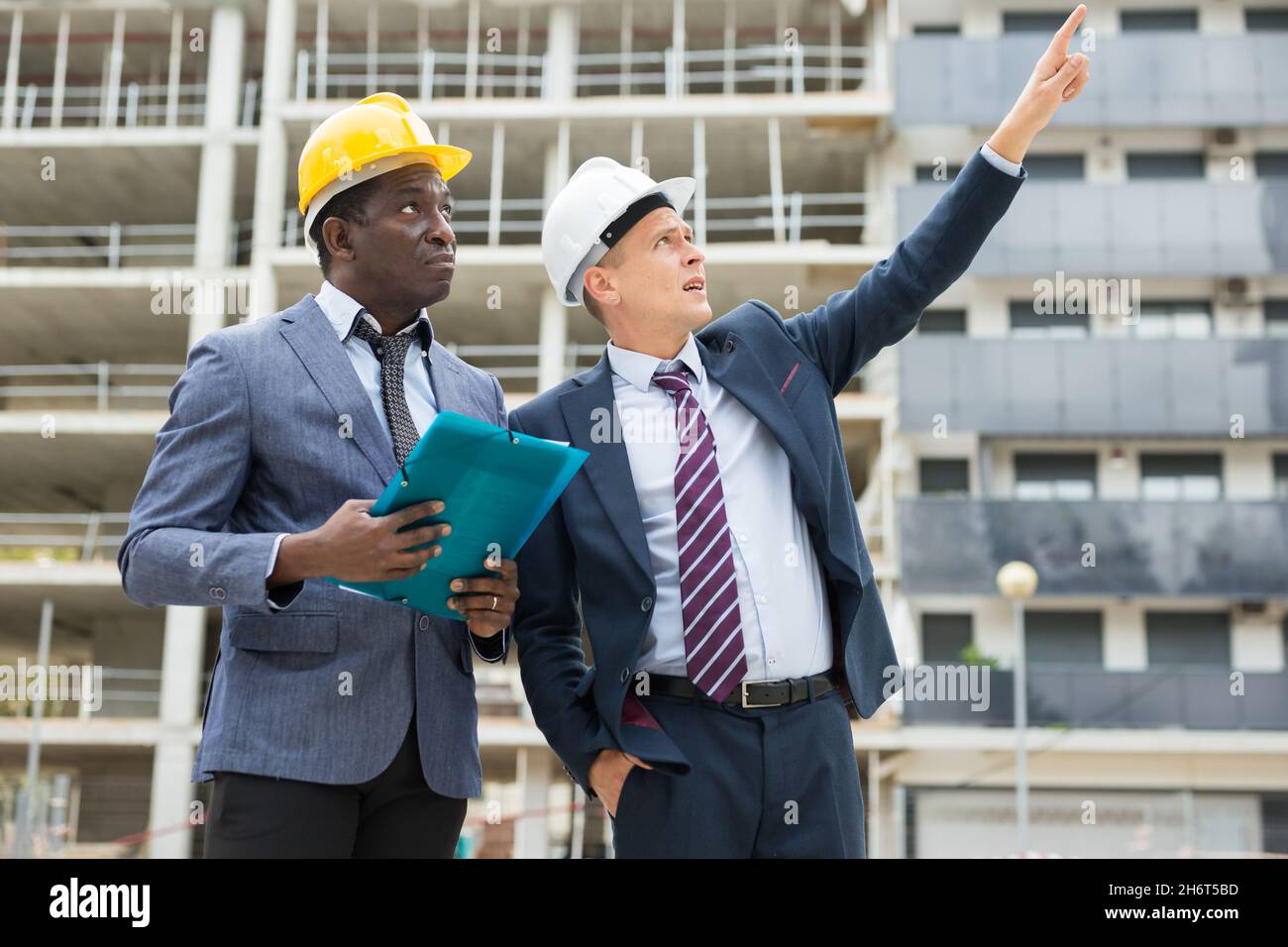 Two engineers discussing new construction Stock Photo - Alamy