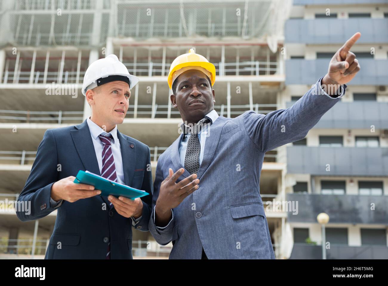 Two engineers discussing new construction Stock Photo - Alamy