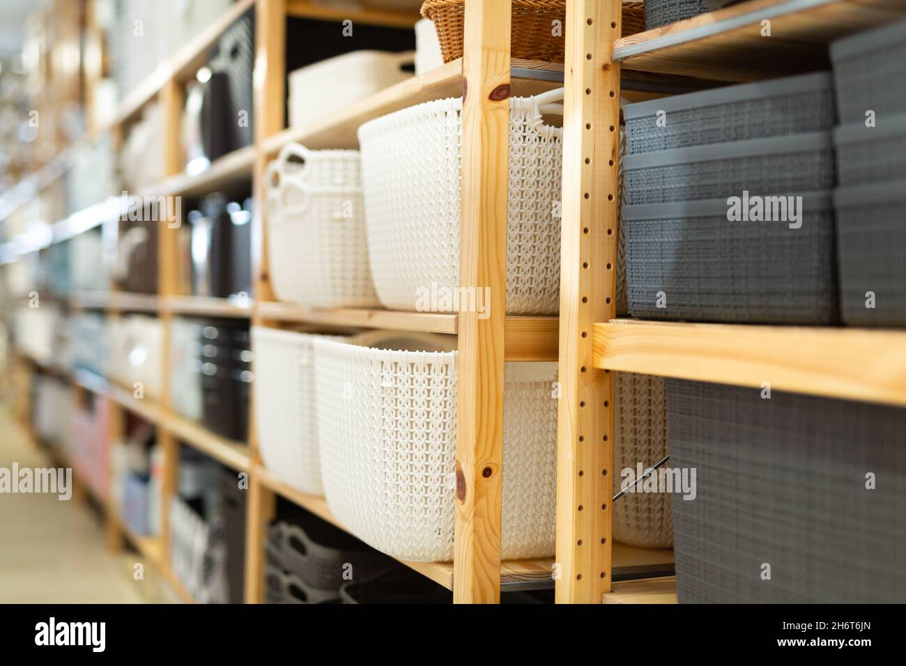 Decorative plastic storage boxes on shelves of store Stock Photo - Alamy