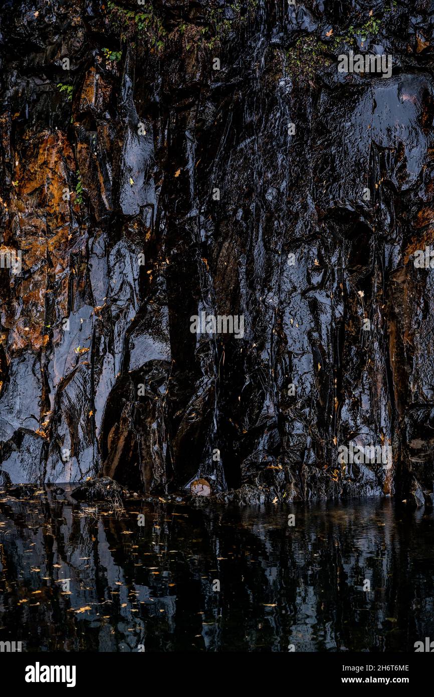 Still Dark Water Sits Below Dark Wet Stone Wall at Cattail Falls in Big ...